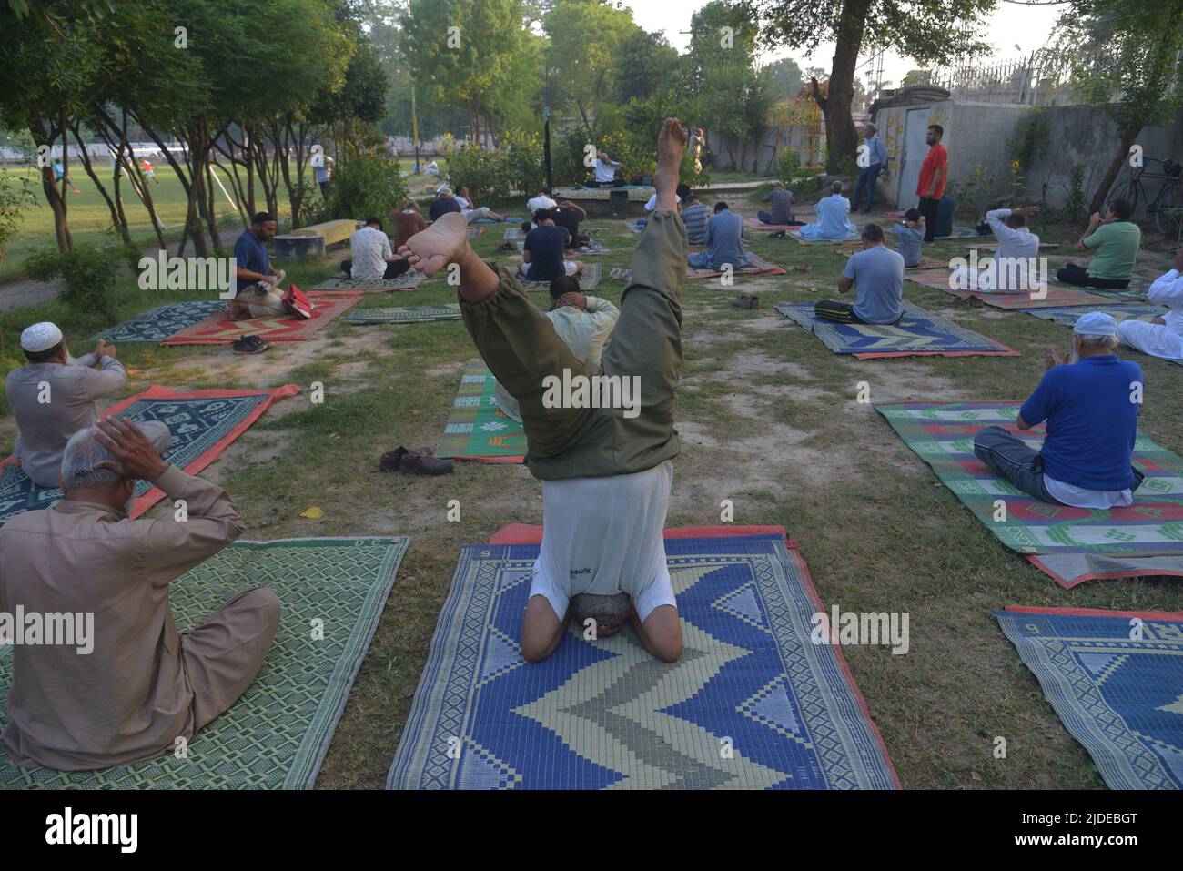 Lahore, Pakistan. 20th June, 2022. Pakistani people performing yoga ...