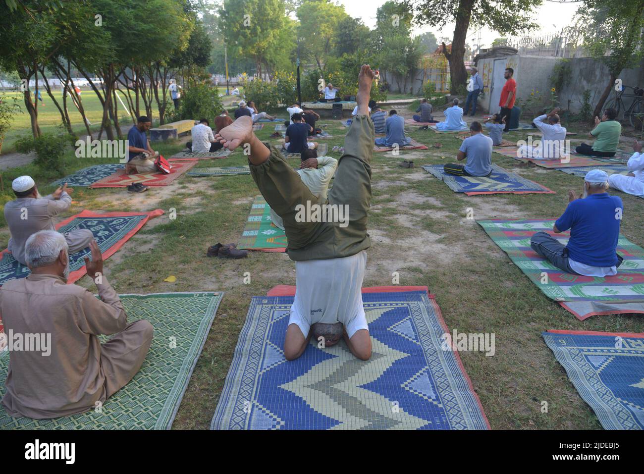 Lahore, Pakistan. 20th June, 2022. Pakistani people performing yoga ...