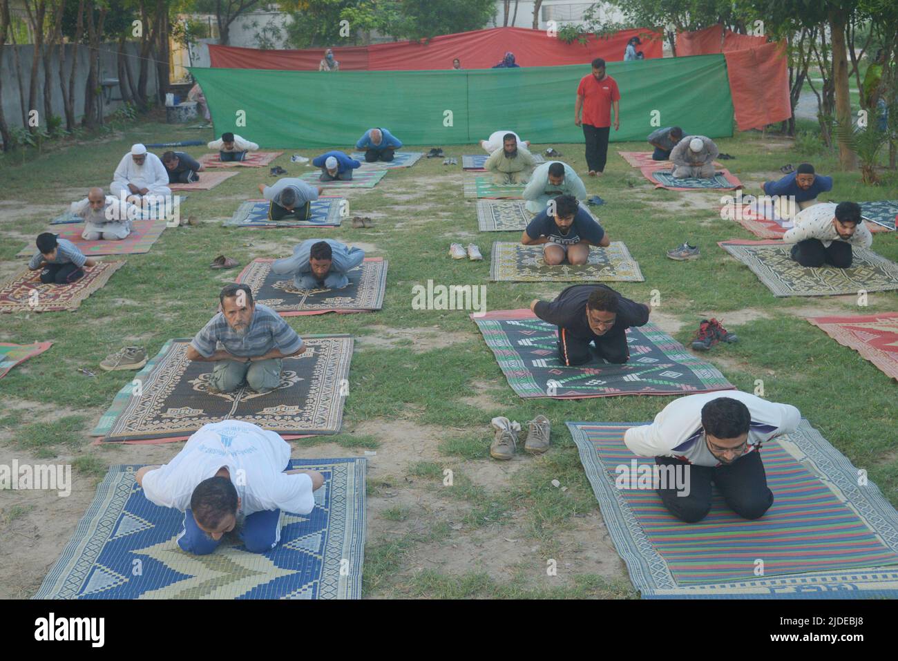 Lahore, Pakistan. 20th June, 2022. Pakistani people performing yoga ...