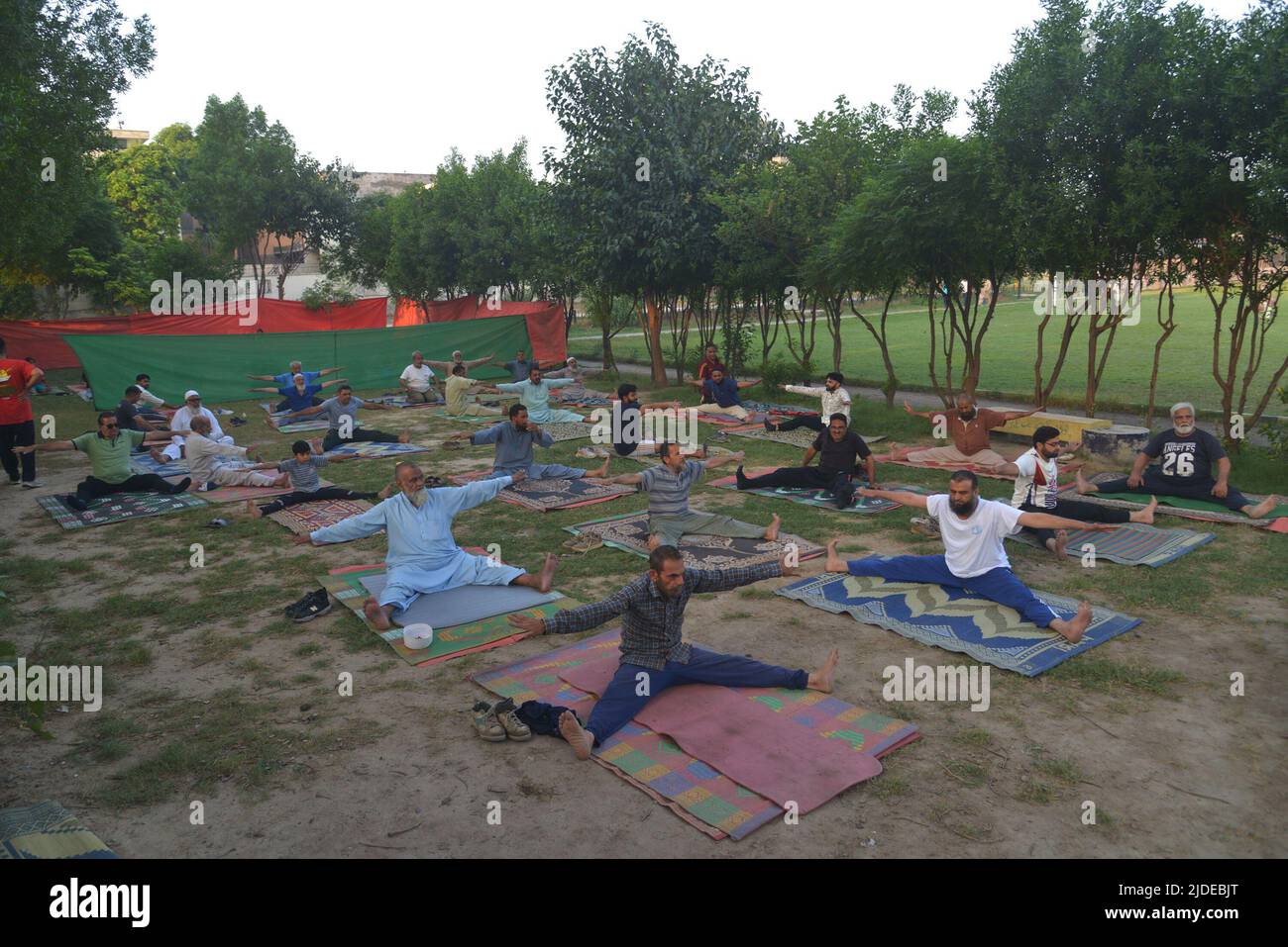 Lahore, Pakistan. 20th June, 2022. Pakistani people performing yoga ...