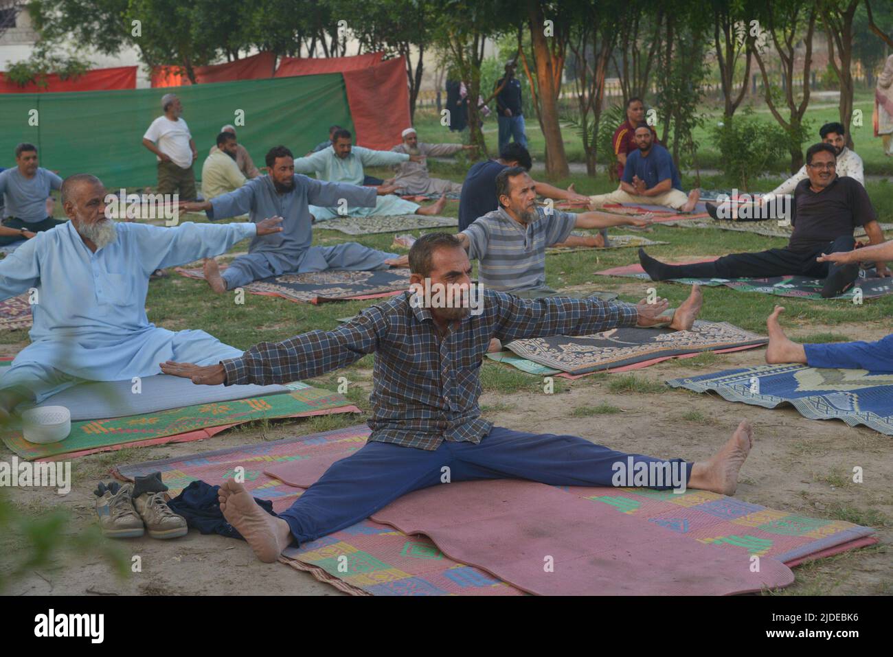 Lahore, Pakistan. 20th June, 2022. Pakistani people performing yoga ...