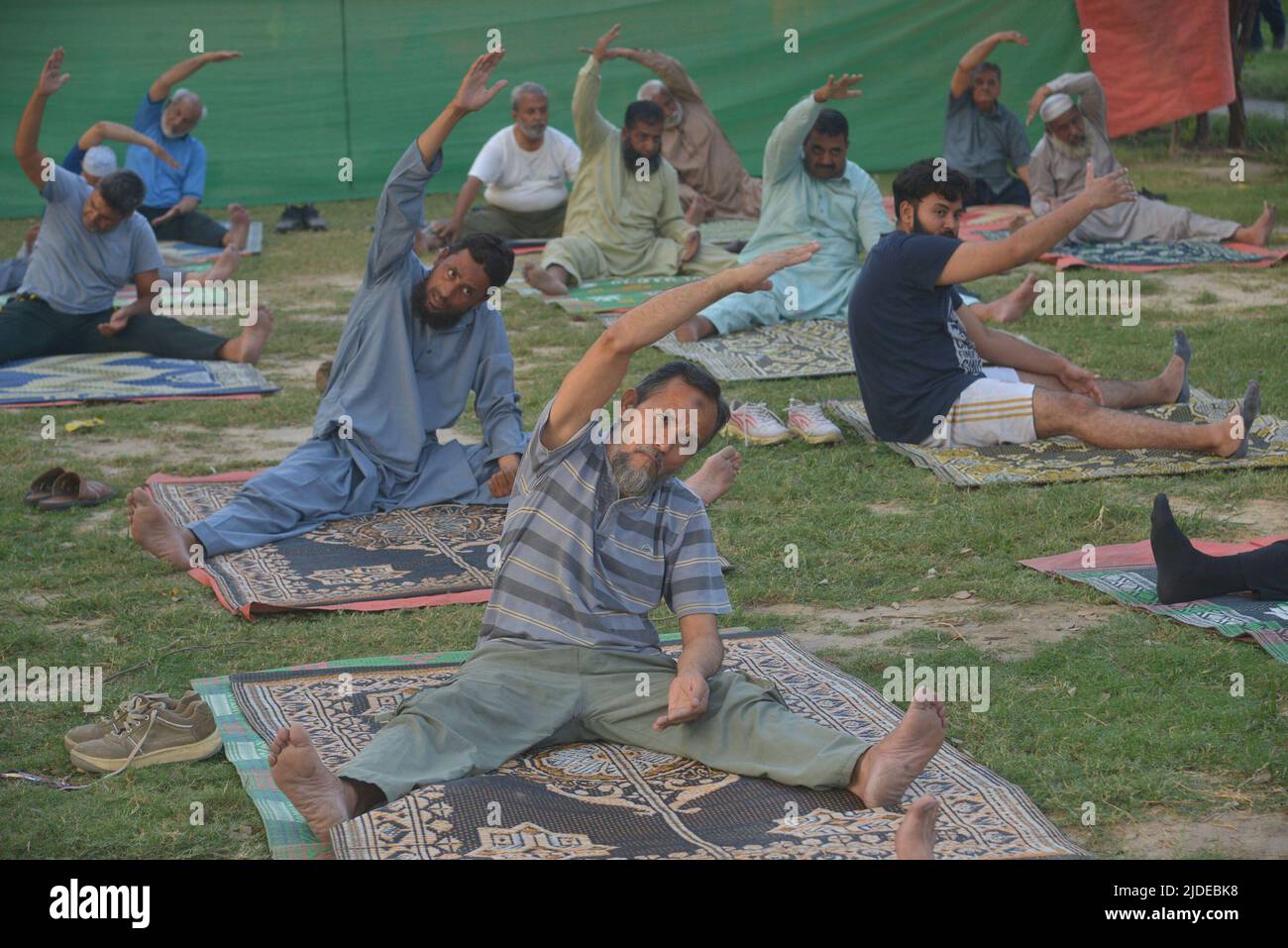 Lahore, Pakistan. 20th June, 2022. Pakistani people performing yoga ...