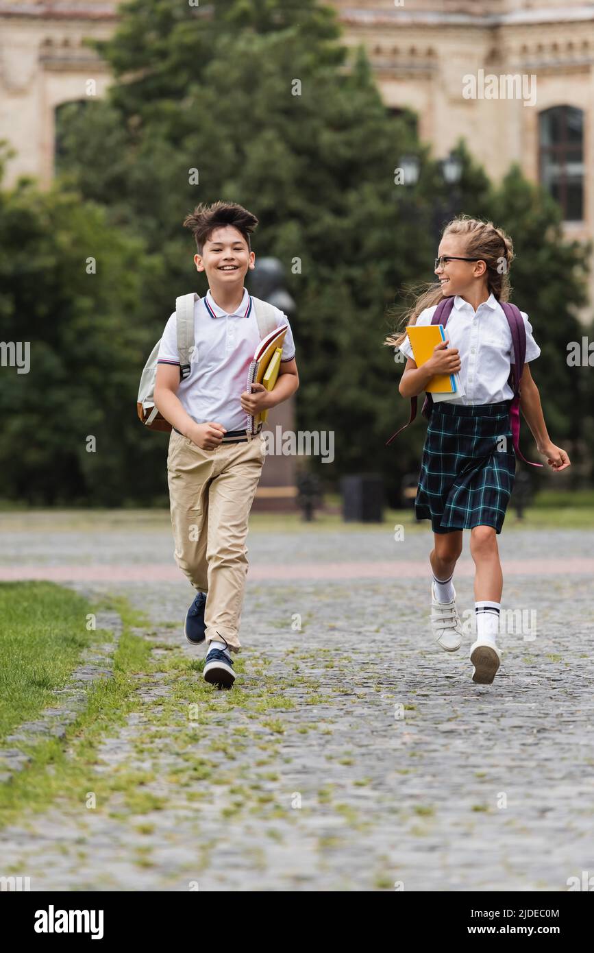 Children running with backpacks hi-res stock photography and images - Alamy