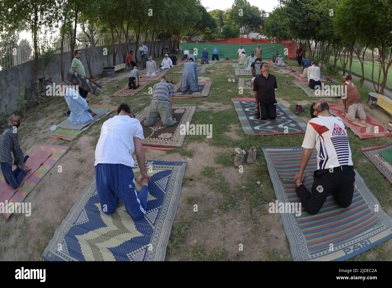 Lahore, Pakistan. 20th June, 2022. Pakistani people performing yoga ...