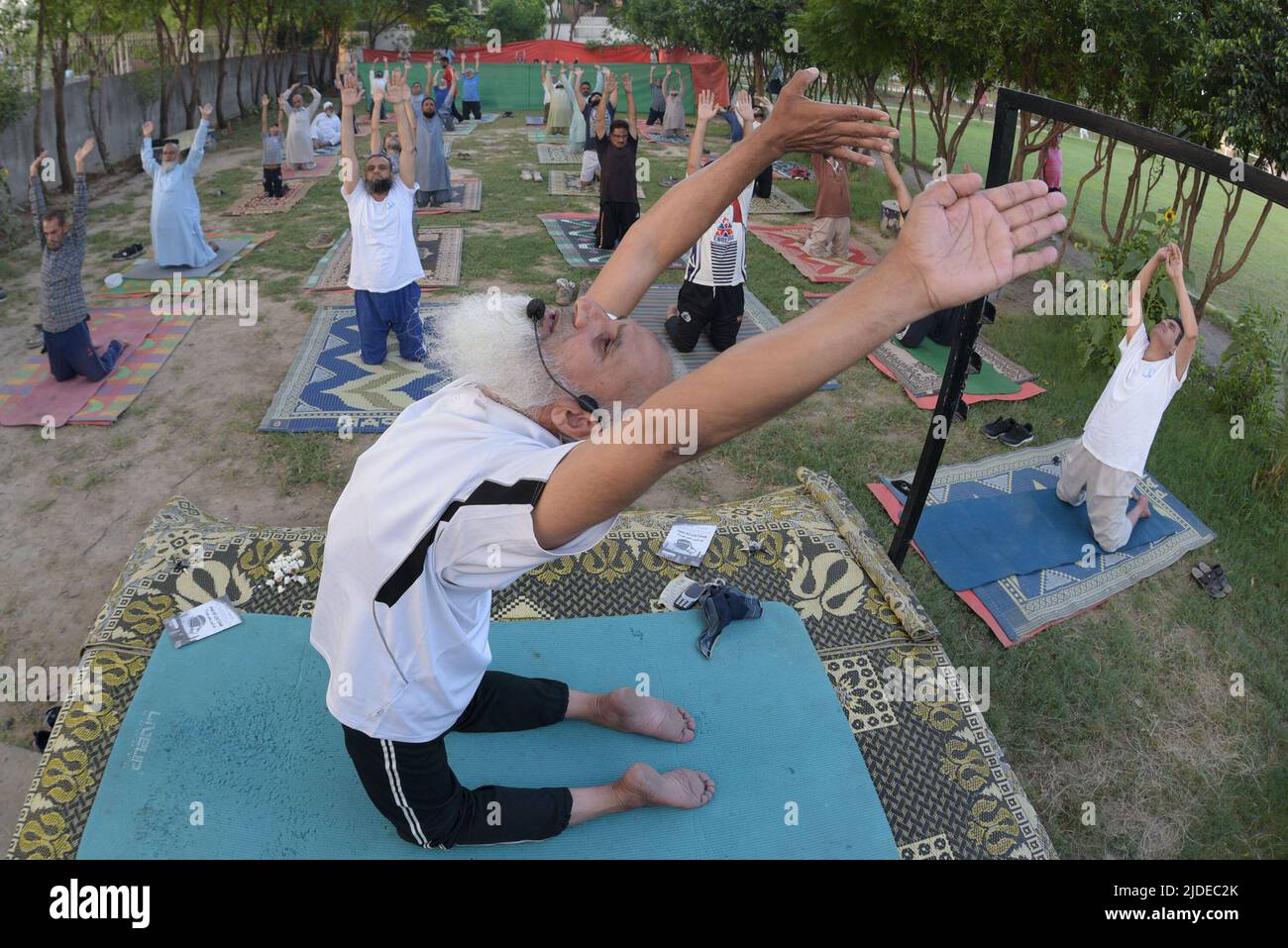 Lahore, Pakistan. 20th June, 2022. Pakistani people performing yoga ...