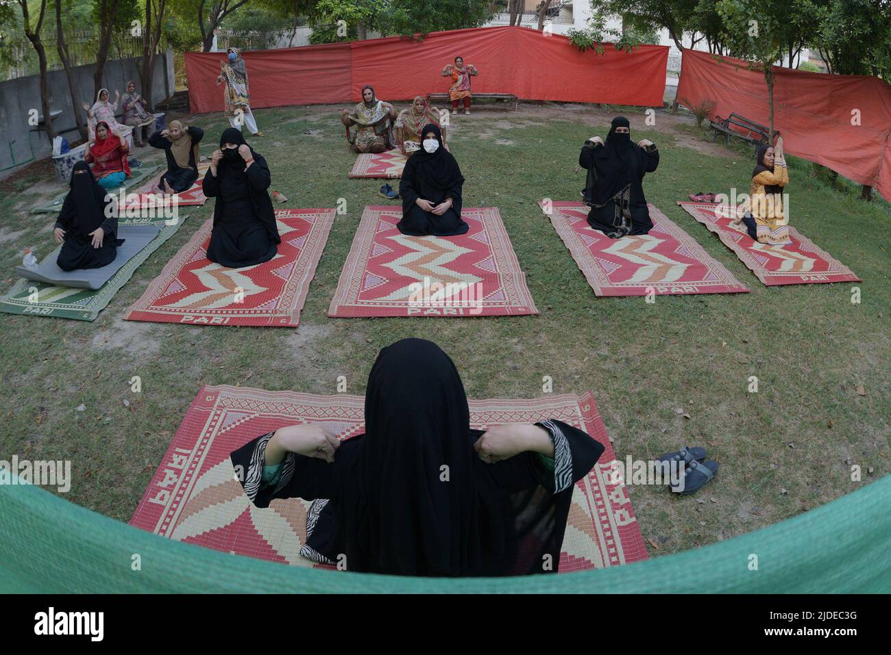 Lahore, Pakistan. 20th June, 2022. Pakistani people performing yoga ...