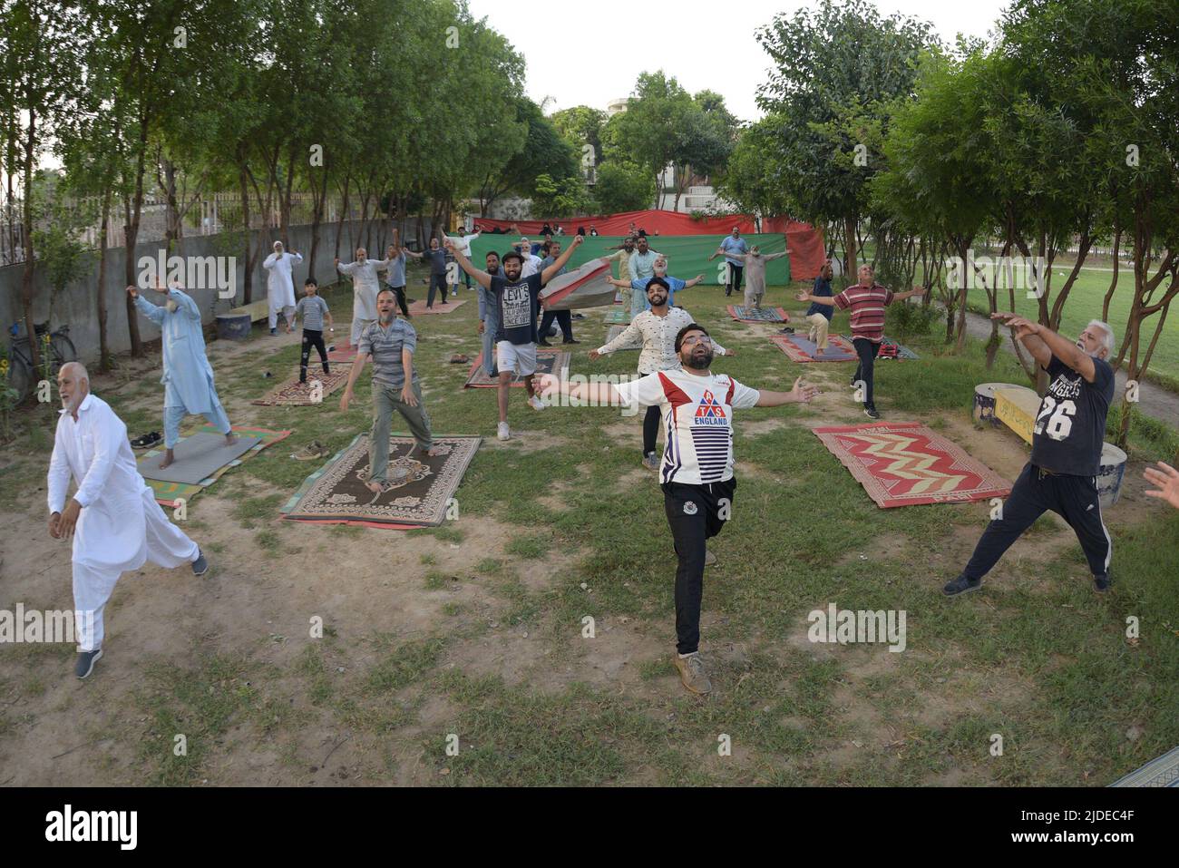 Lahore, Pakistan. 20th June, 2022. Pakistani people performing yoga ...