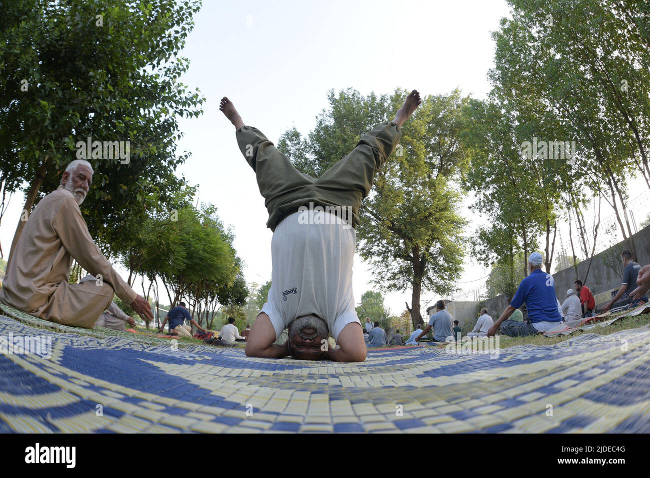 Lahore, Pakistan. 20th June, 2022. Pakistani people performing yoga ...