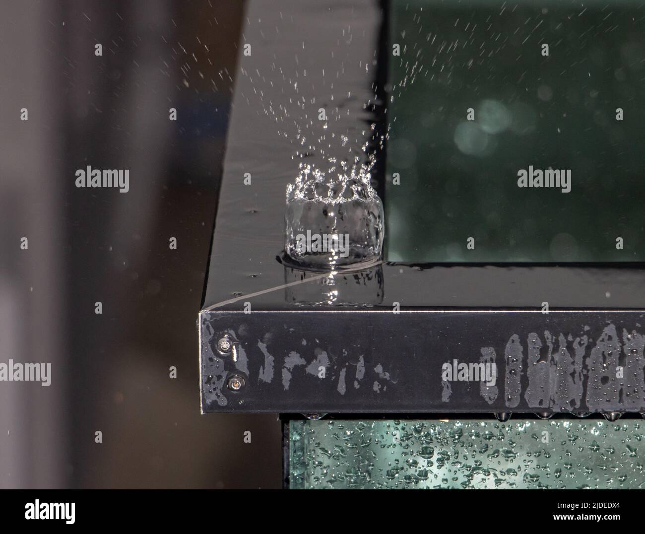 A drop of rain fall on a railing on a balcony Stock Photo - Alamy