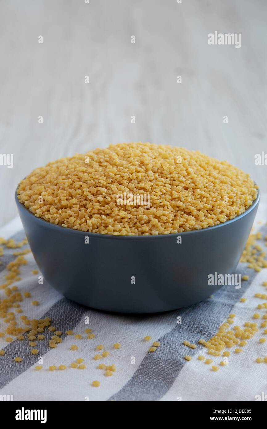 Raw Organic Stelline Pasta in a Bowl, side view. Close-up Stock Photo ...