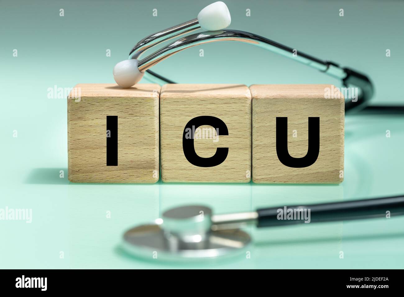 Medical stethoscope, wooden blocks with the words ICU intensive care ...