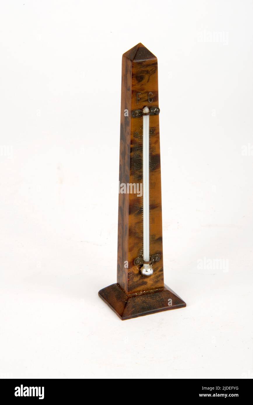 A selection of bakelite and plastic items. Thermometer on an obelisk ...