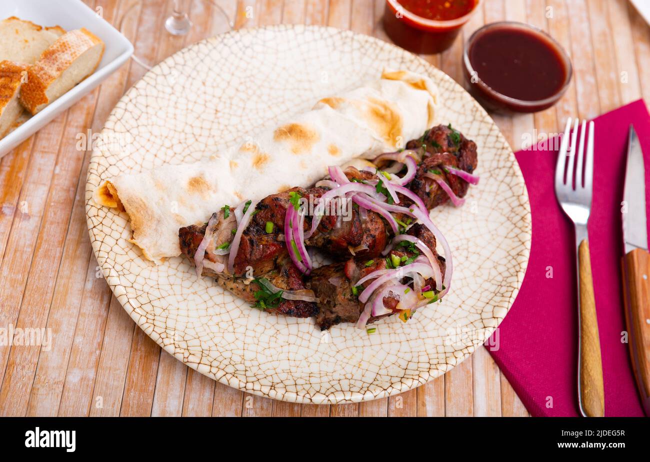 Grilled pork meat shashlik with marinated onion Stock Photo - Alamy