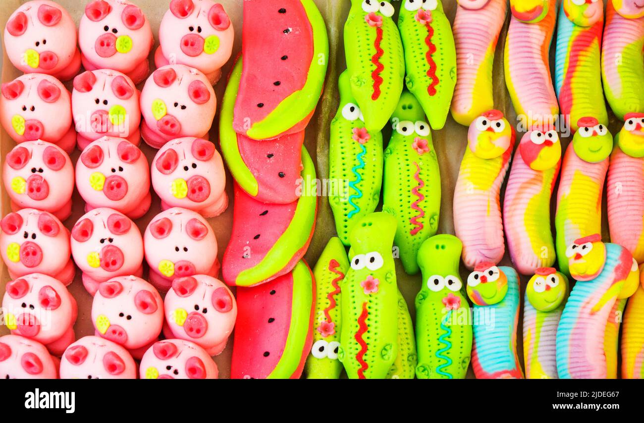 colorful chewable caramel in the form of different animals and fruits ...