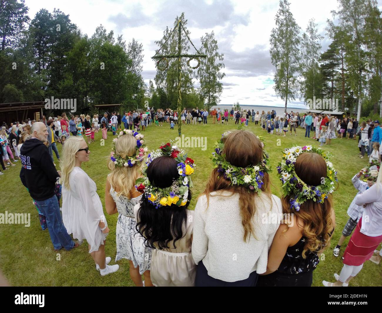 Raising and dancing around a maypole during a midsummer celebration in ...