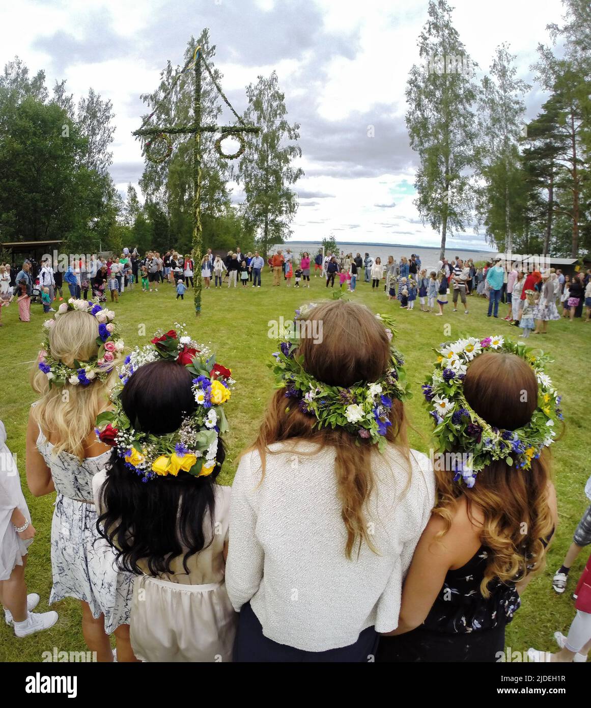 Raising and dancing around a maypole during a midsummer celebration in ...
