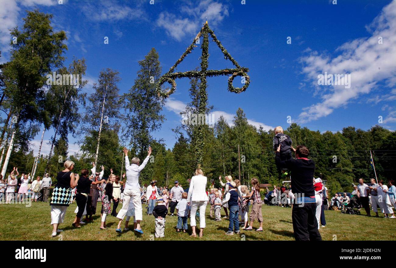 Raising and dancing around a maypole during a midsummer celebration in ...