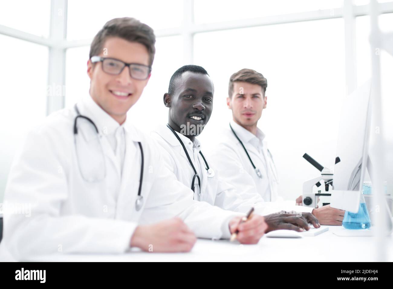 laboratory staff sitting at the Desk Stock Photo - Alamy