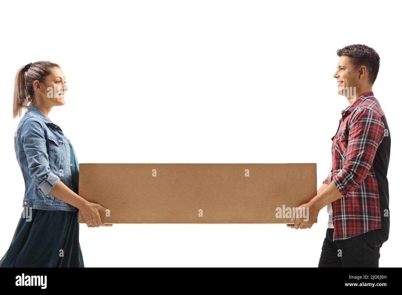 Young man and woman holding a cardboard box isolated on white ...