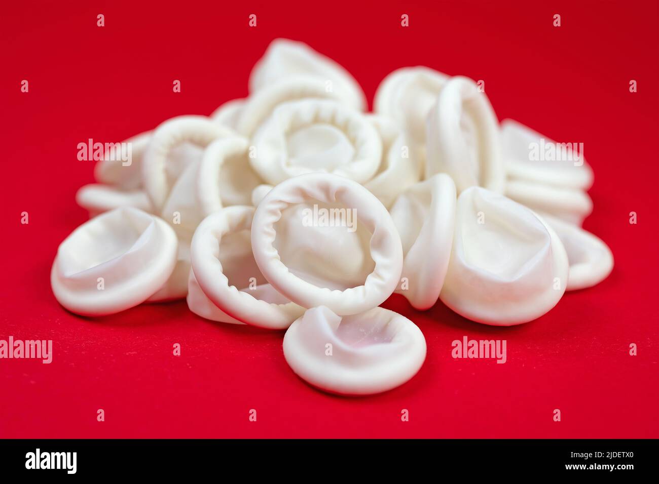 Latex finger stalls against a red background Stock Photo - Alamy
