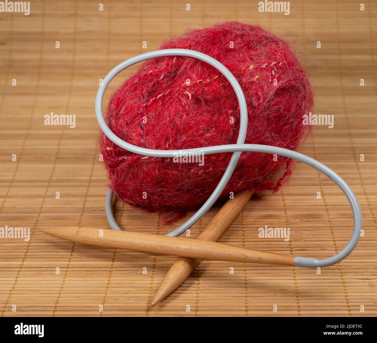Red mohair wool and knitting needles Stock Photo - Alamy