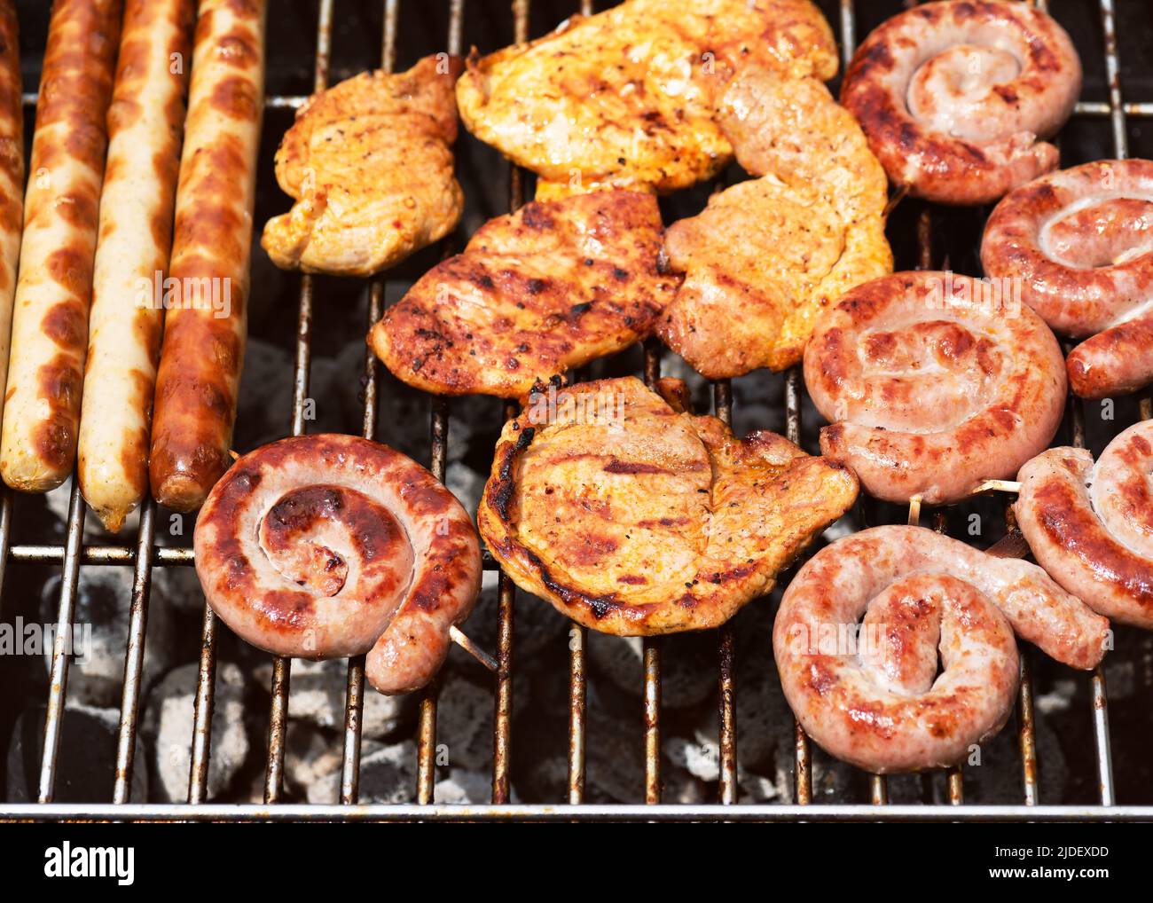 Assorted delicious grilled meat over the hot fire on a portable ...