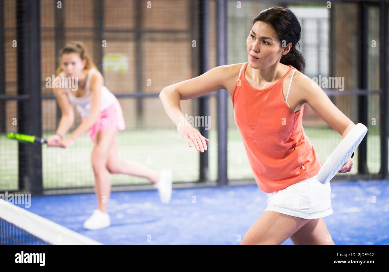 Young asian woman playing padel on a hard court Stock Photo - Alamy