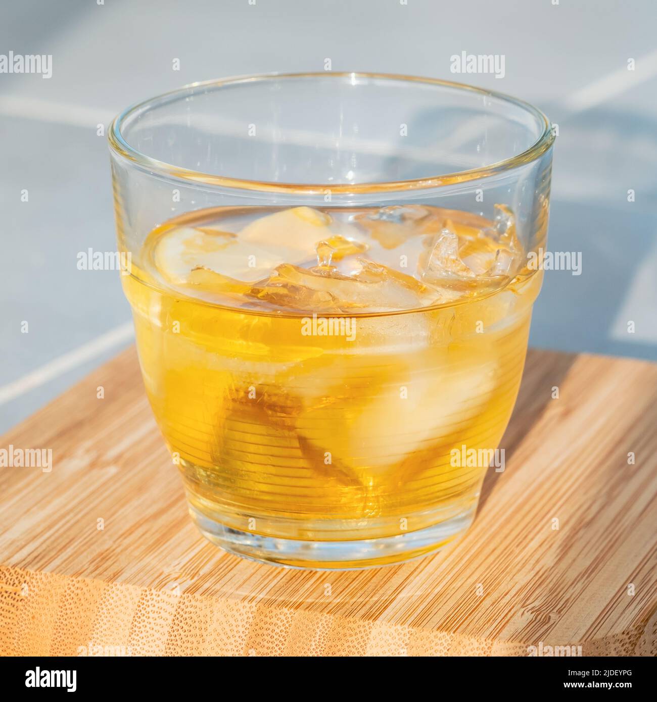 Glass of golden rum on the rocks Stock Photo - Alamy