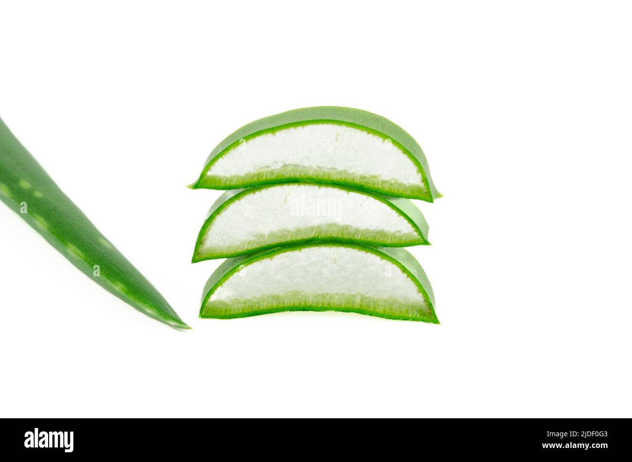 Small pieces of an aloe vera leaf forming a pile on a white background ...