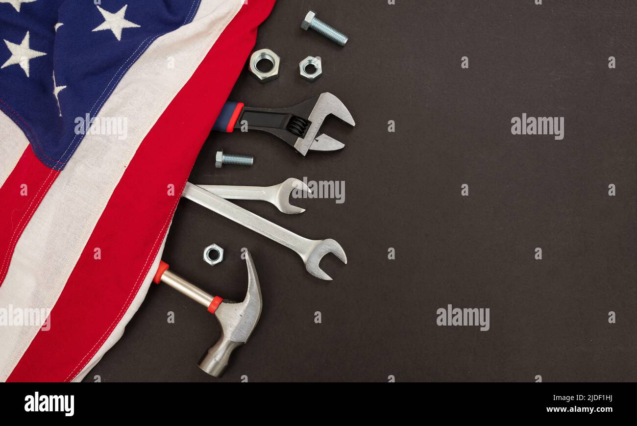 Labor day, USA flag and work tool on black color background. US of ...