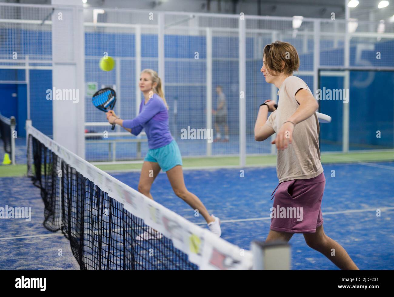 Portrait of a boy-athlete and a woman tennis player playing padel Stock ...