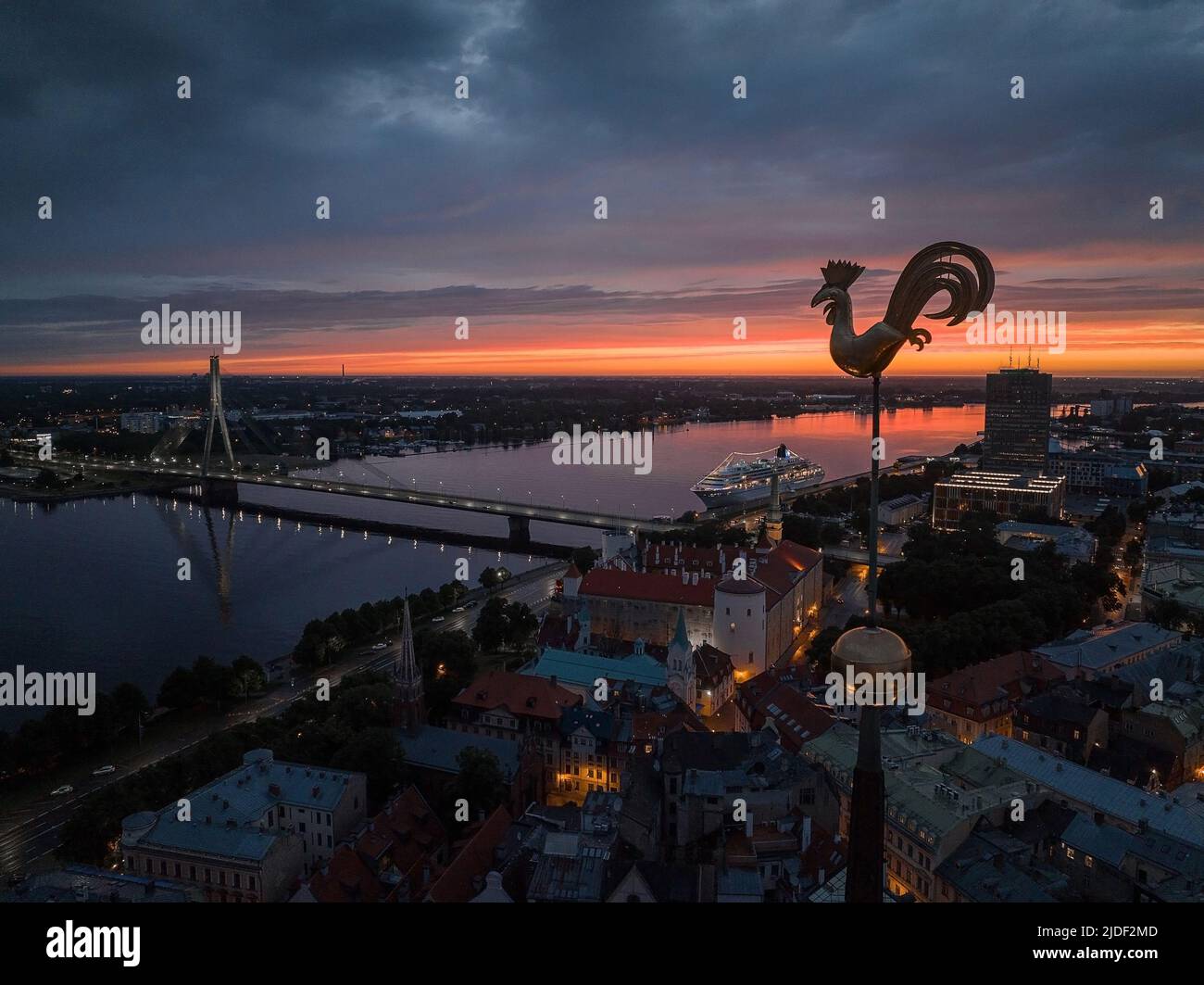 Symbol of old Riga town - golden cockerel, rooster topping bell tower ...