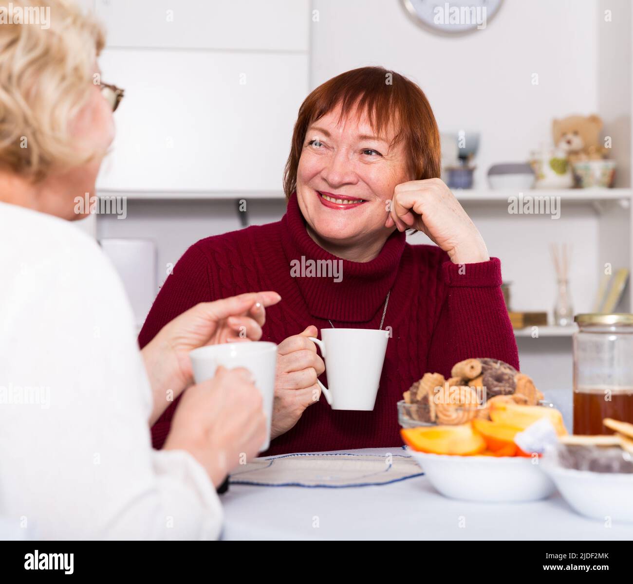 Positive old women drinking tea at the table Stock Photo - Alamy