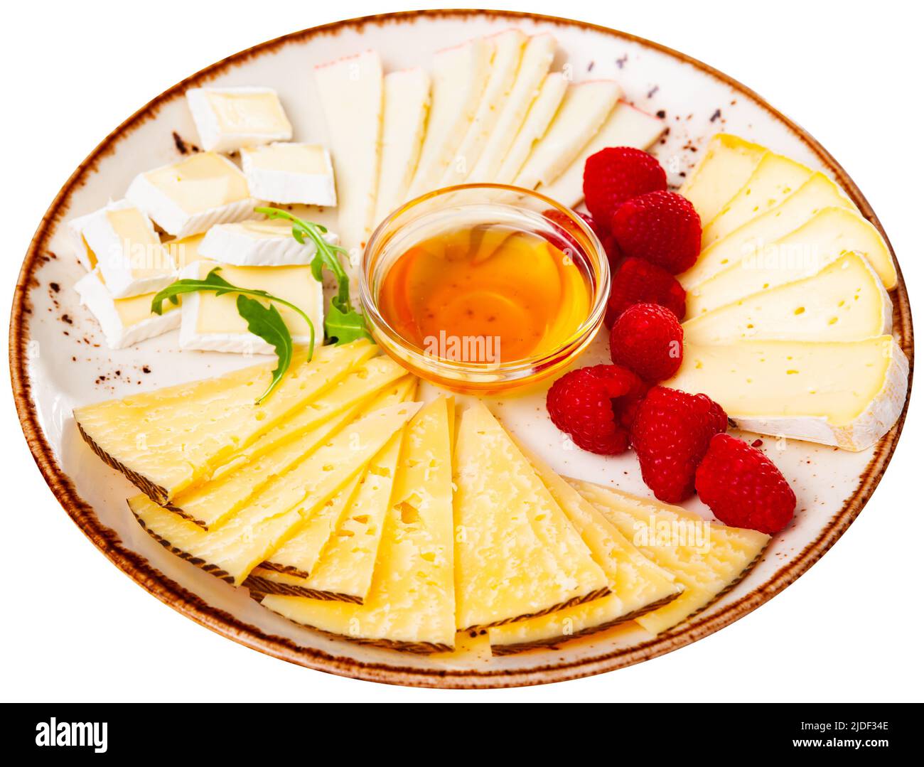 Different types of cheese sliced and served on plate, on white ...