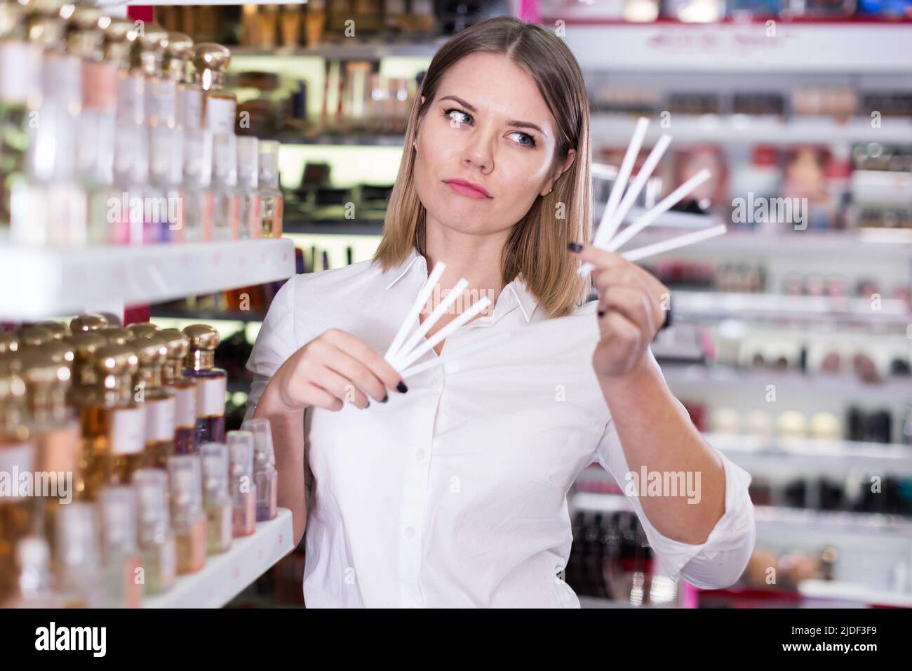 Attractive girl testing fragrance with tester Stock Photo - Alamy