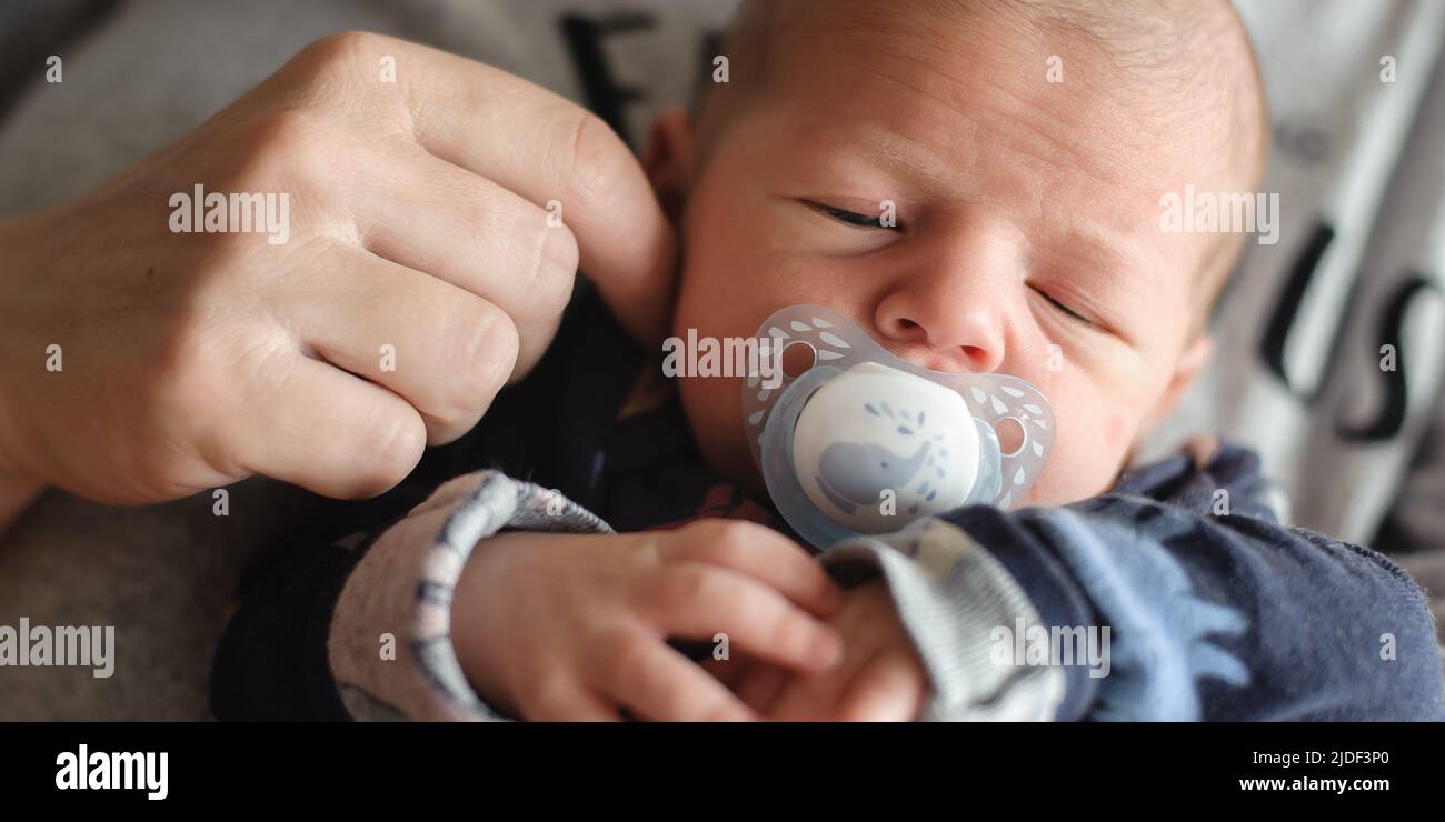 Close-up detail portrait of mother holding cute little peaceful newborn ...
