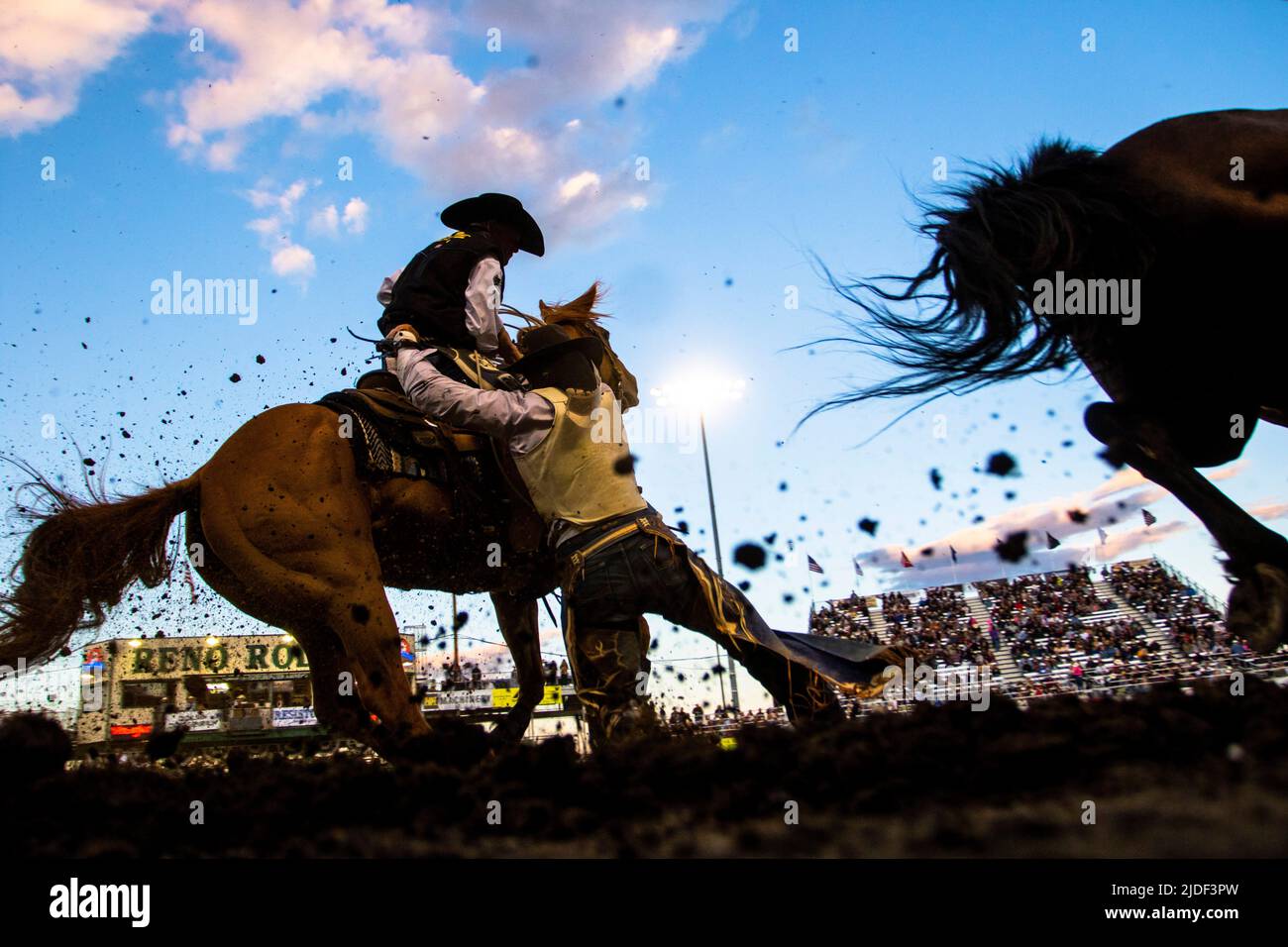 Pick up men grab Kody Lamb after his ride. The Reno Rodeo taking place ...