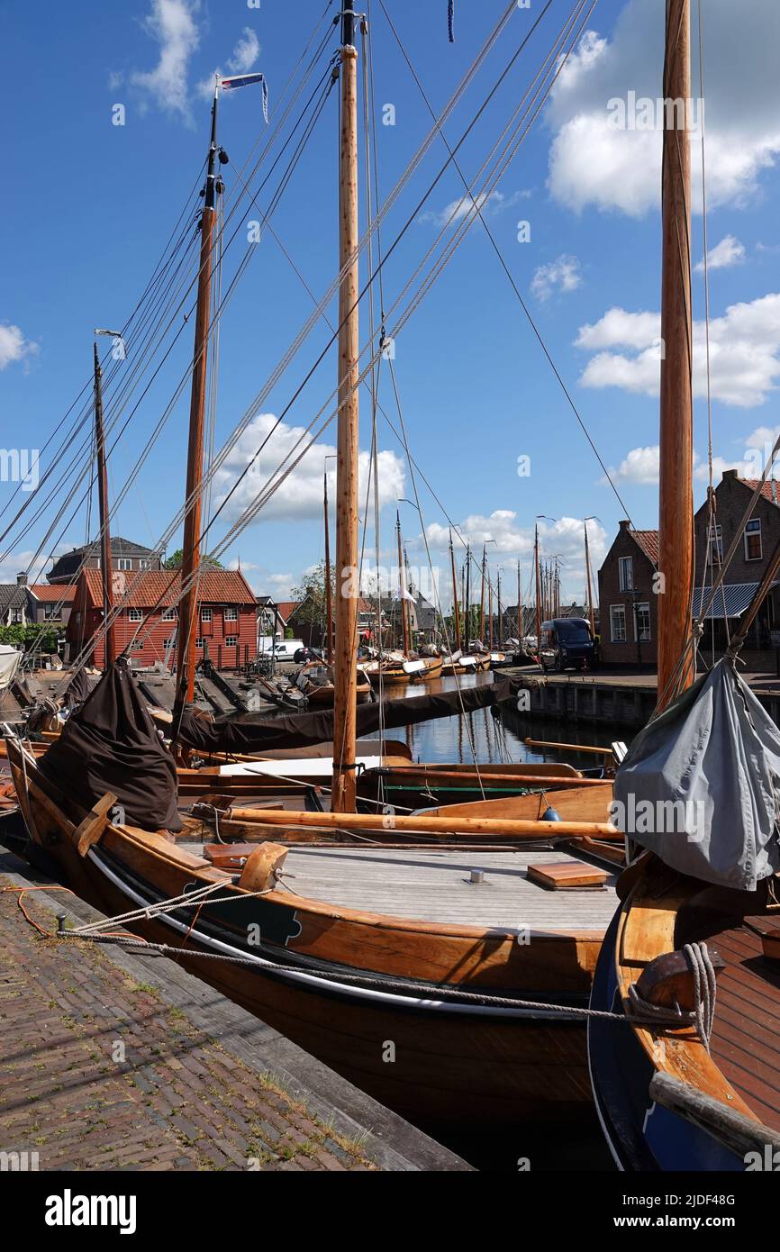 Old historical wooden fishing boats moored behind each other. These are ...