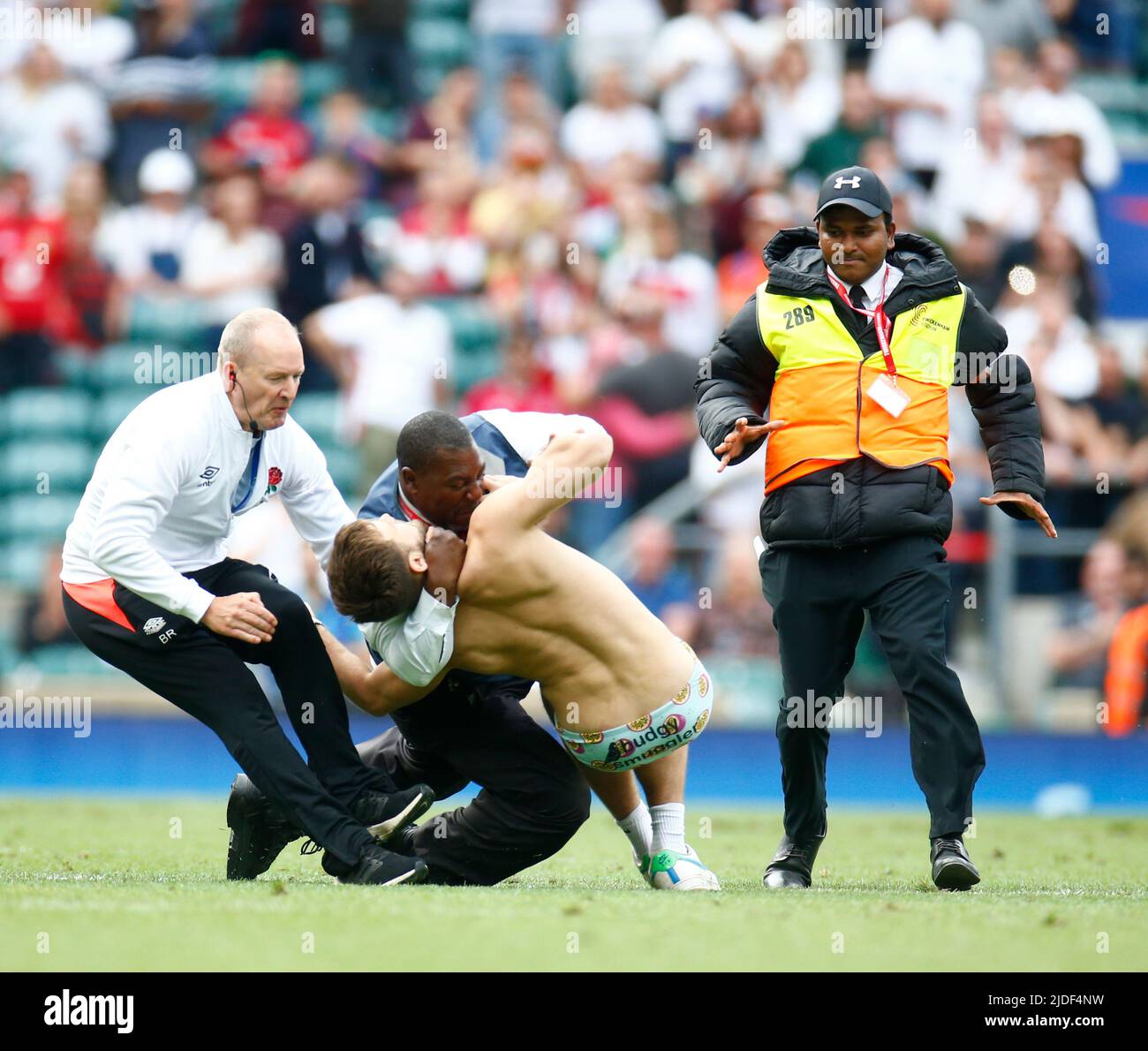 LONDON ENGLAND - JUNE 19 : Pitch invader is tackled by security and an ...