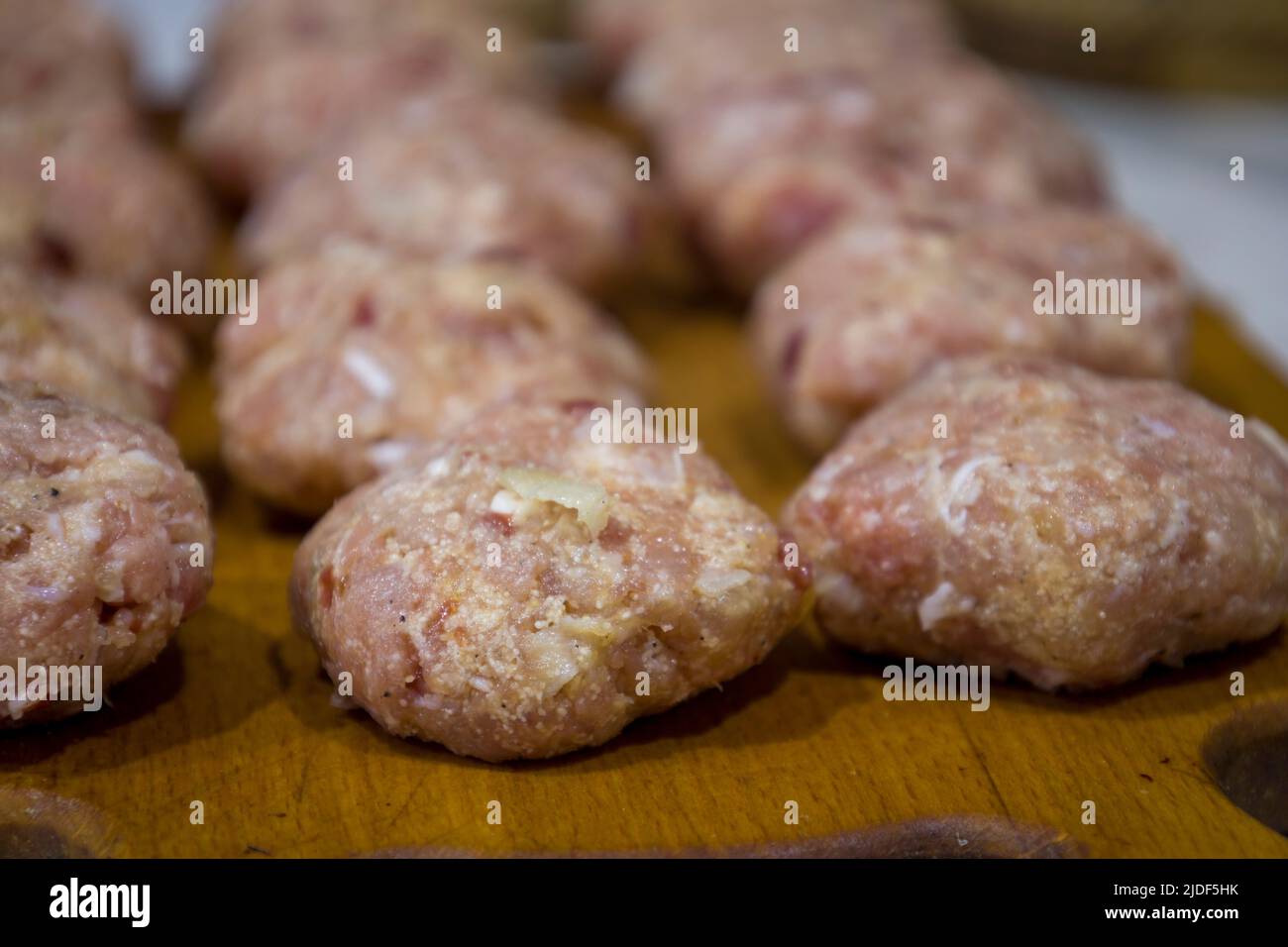 Raw meatballs on the board Stock Photo - Alamy