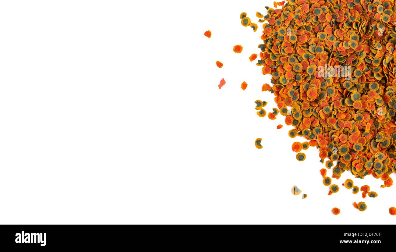 Dry multi-colored compound fish feed flakes in a transparent box on ...