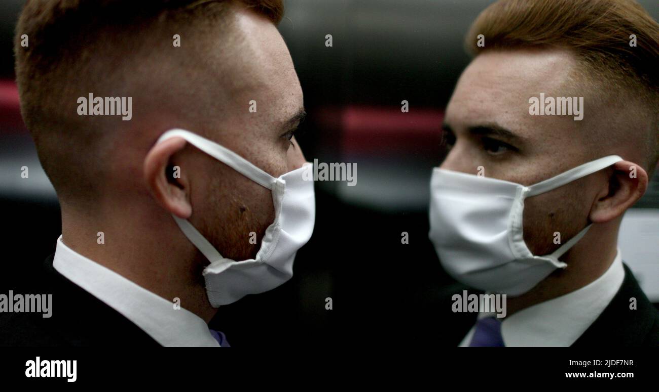 Business man commuting wearing covid-19 mask inside elevator, person ...