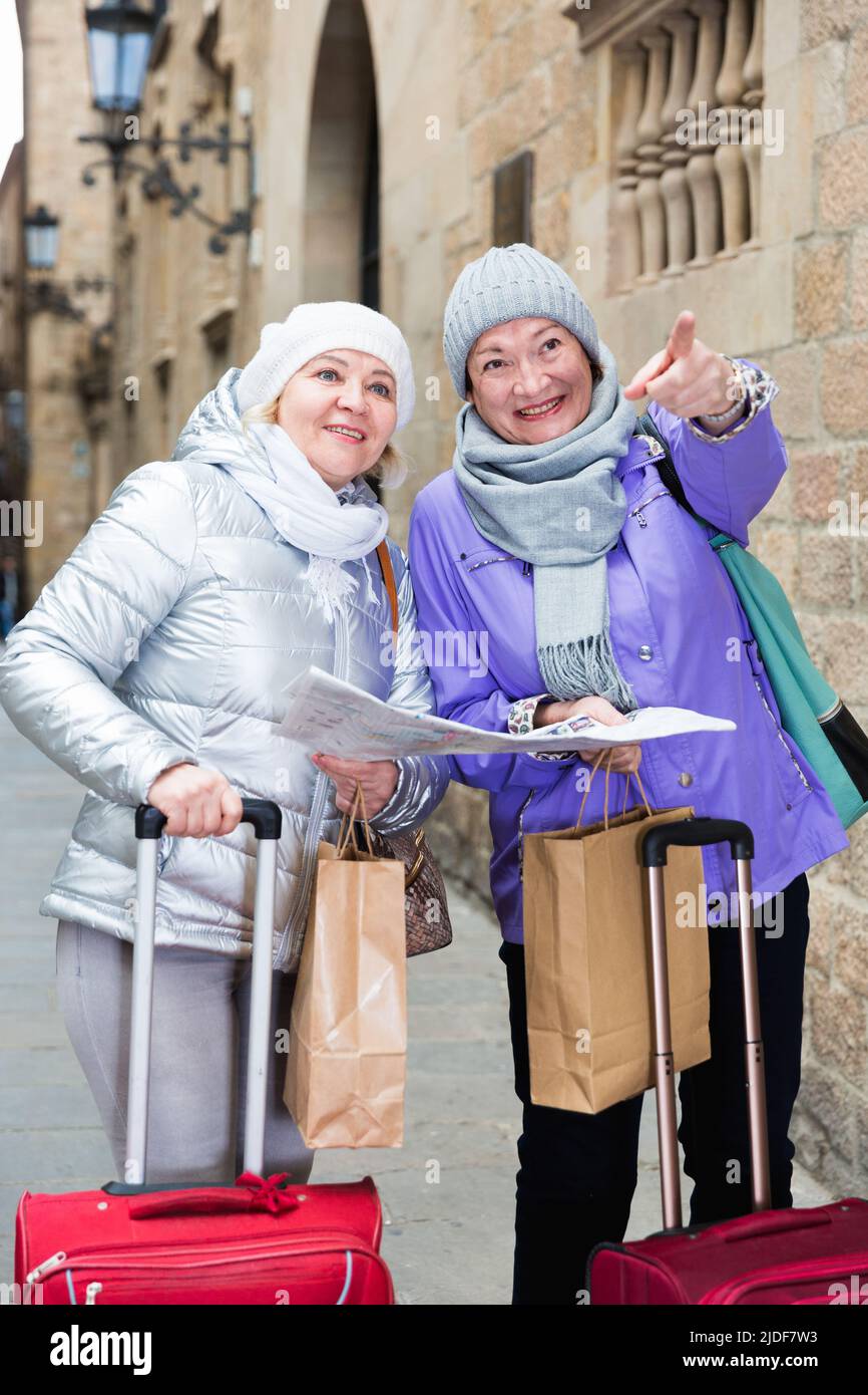Elderly women tourists with city guide Stock Photo - Alamy
