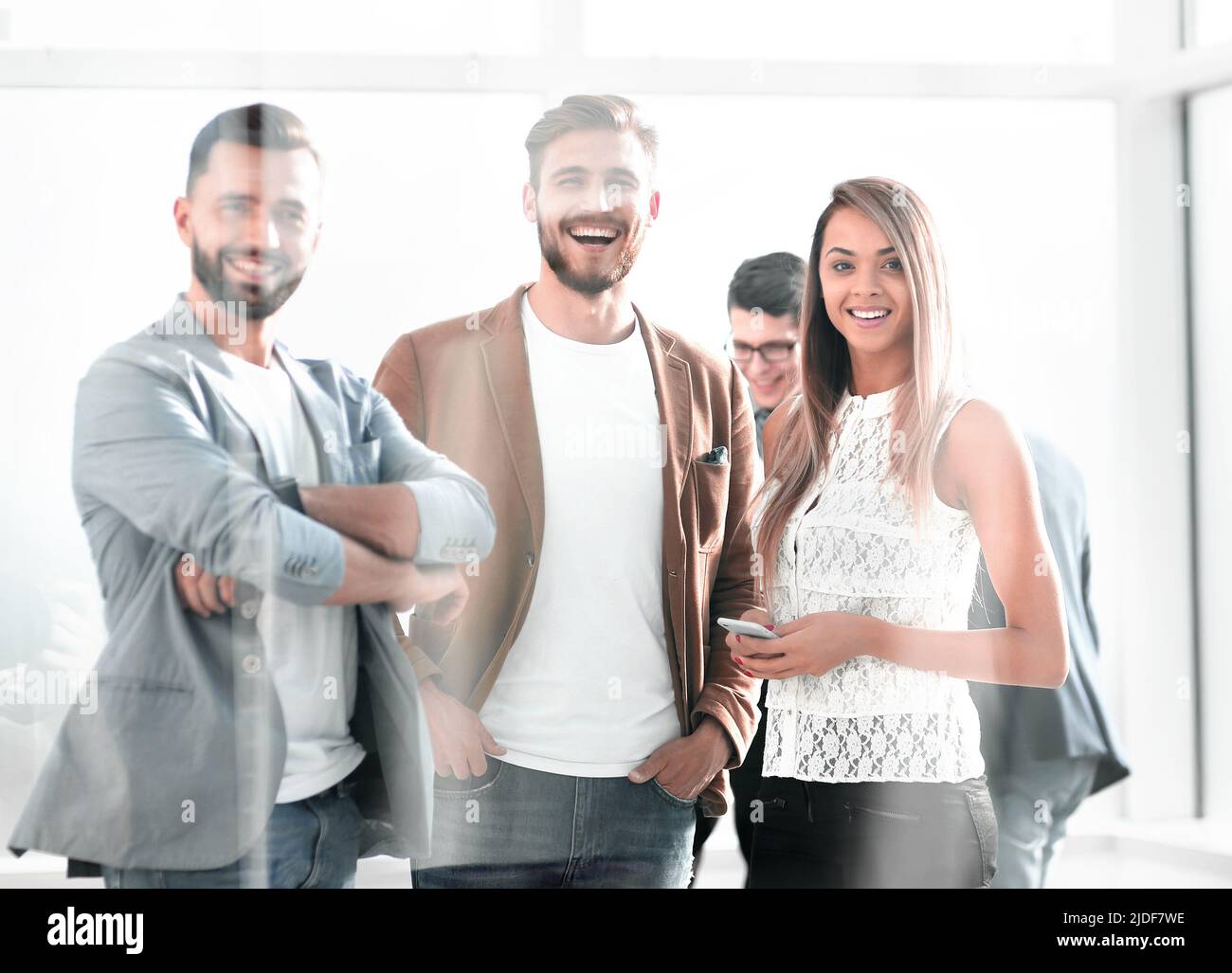 three young employees of the company standing in the office Stock Photo ...