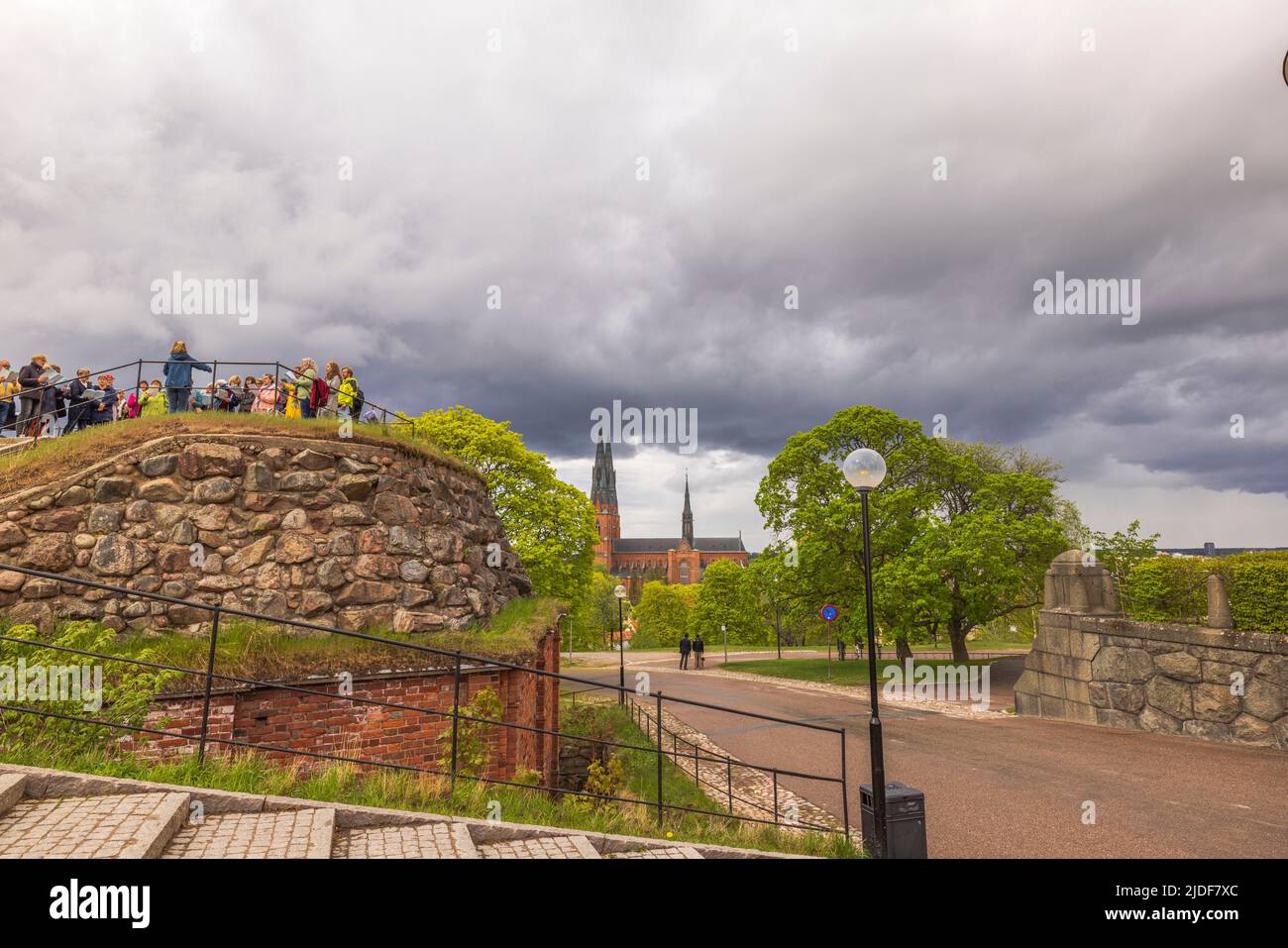 Beautiful Uppsala city landscape view. Tourist group on hill under ...
