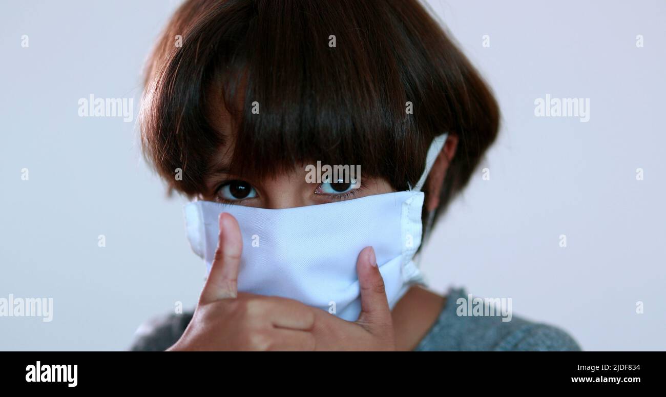 Child wearing surgical mask giving thumbs up, kid portrait wearing ...
