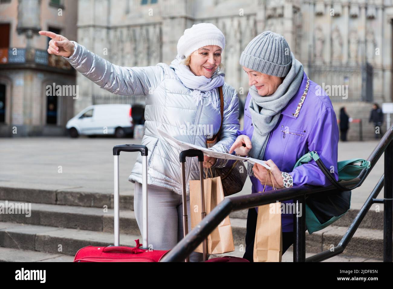 Elderly women tourists with city guide Stock Photo - Alamy