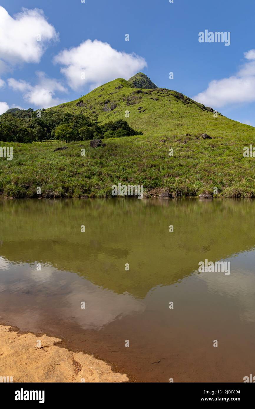 View of the Chembra Peak, with its reflection in the heart shaped lake ...