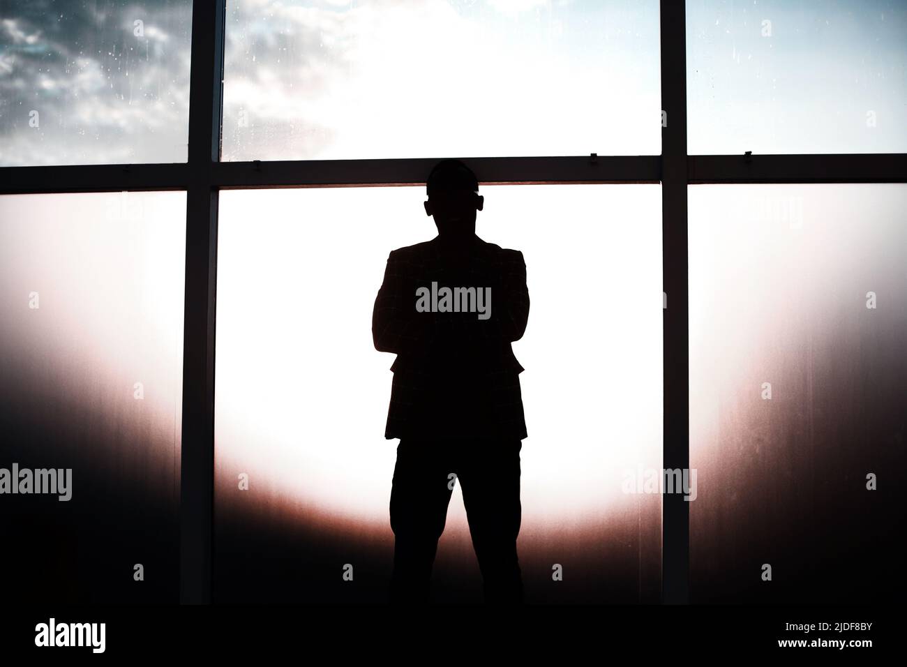 background image. businessman standing near the window Stock Photo - Alamy