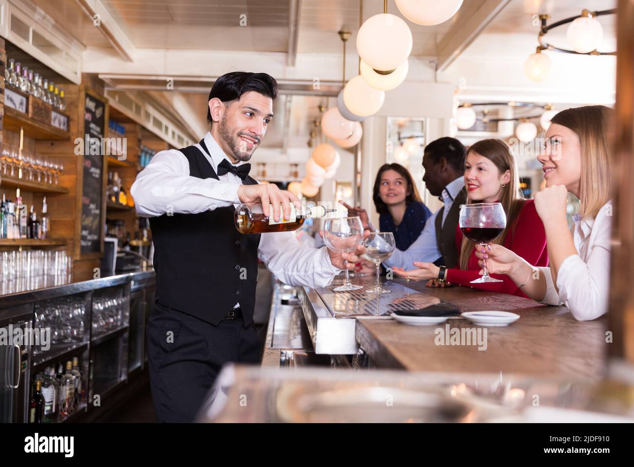 Bartender pouring beverages in bar Stock Photo - Alamy